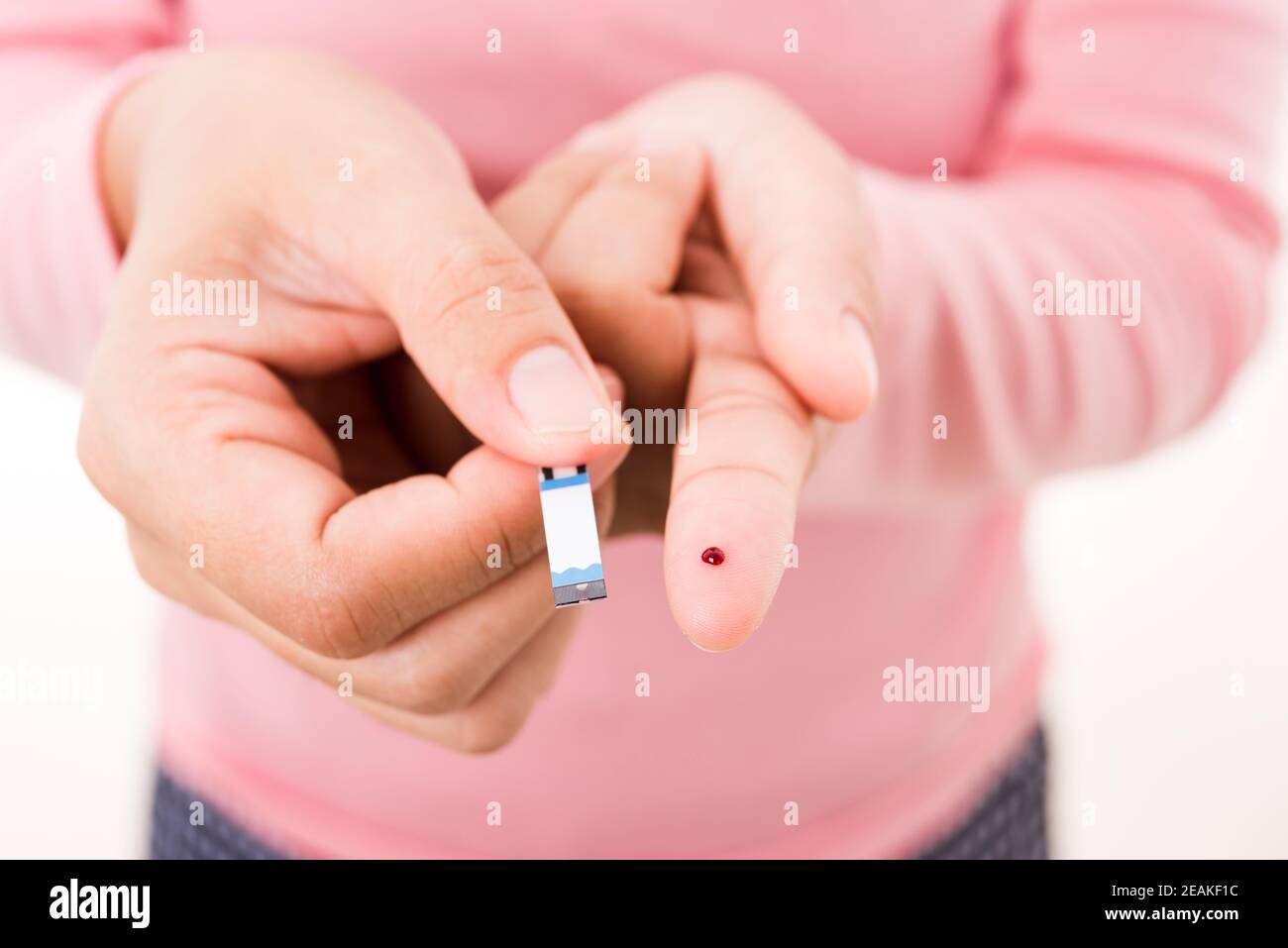 woman holding a plate measuring glucose test level checking with blood ...