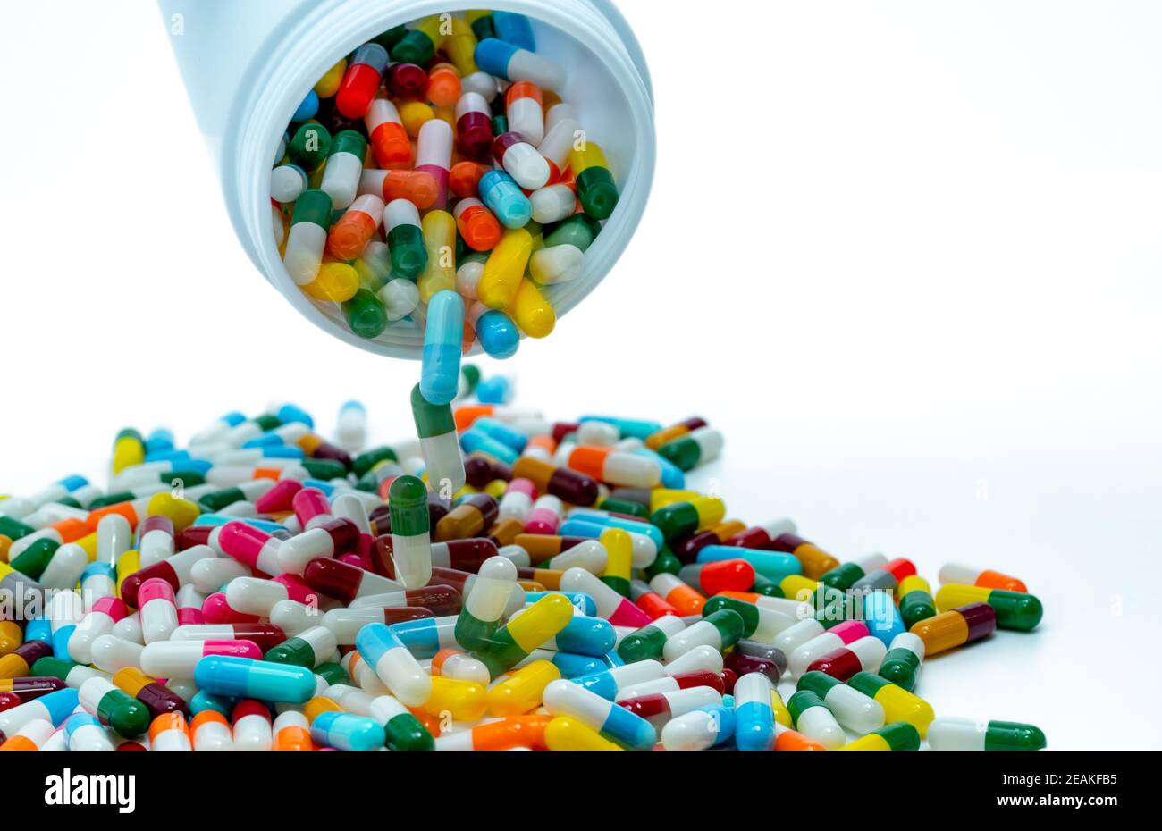 Pouring antibiotic capsule out of plastic bottle. Antibiotic drug ...