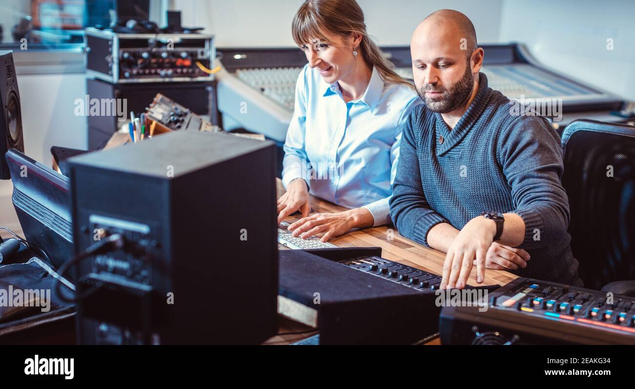 Singer or artist and sound engineer working in the studio Stock Photo ...