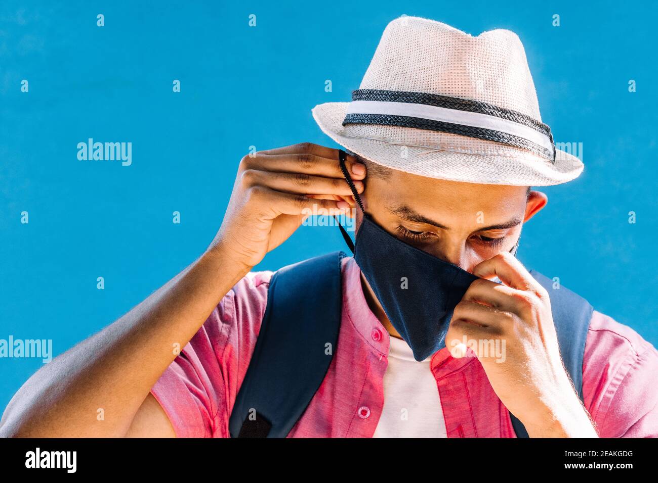 young man taking off his mask Stock Photo - Alamy