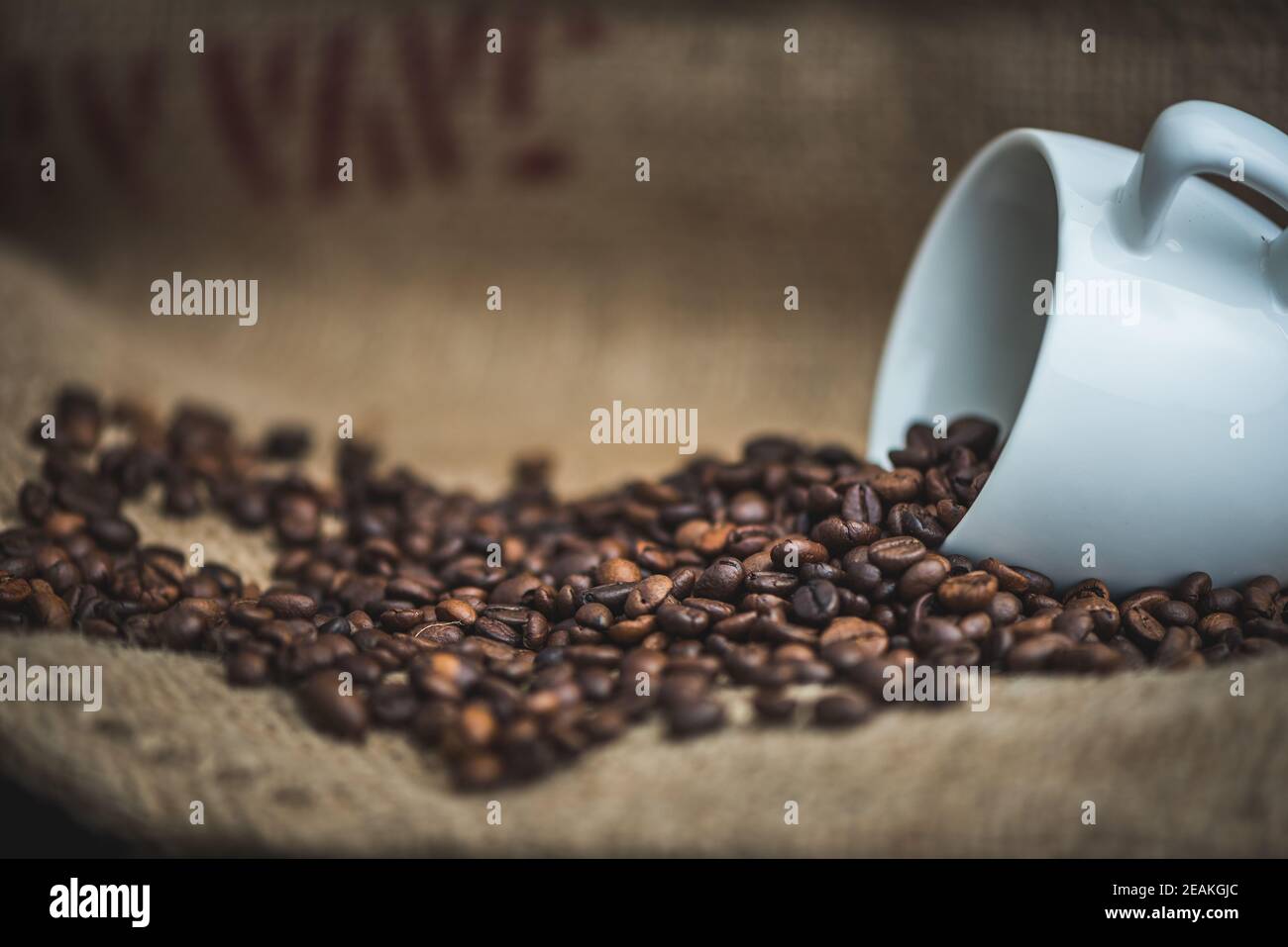 Coffee Beans Spilled out of Cup Stock Photo - Alamy