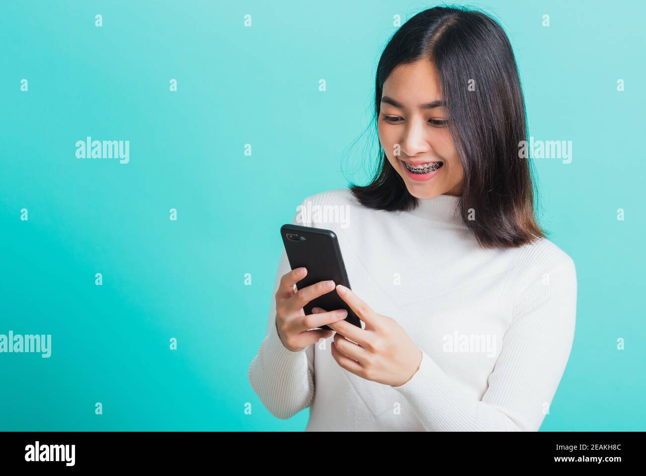 woman smile she holding and typing text message Stock Photo - Alamy