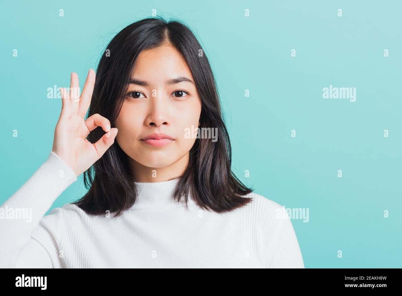 woman smiling and showing hand the OK sign Stock Photo - Alamy