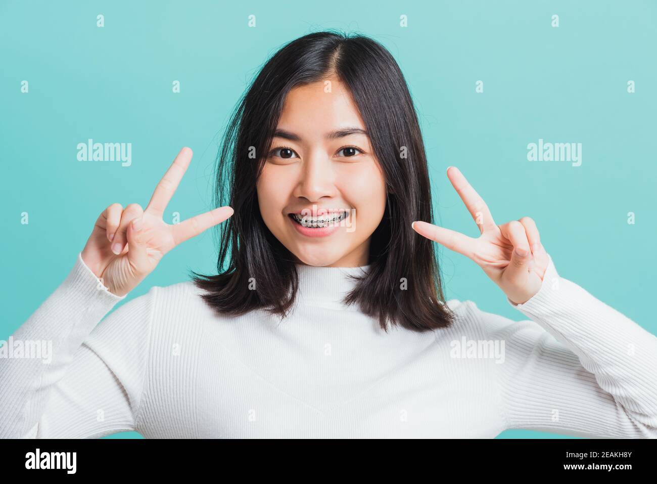 Portrait female give V-sign Stock Photo - Alamy