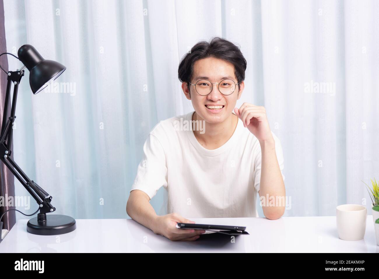 Business man work from home office he using a black modern smart ...