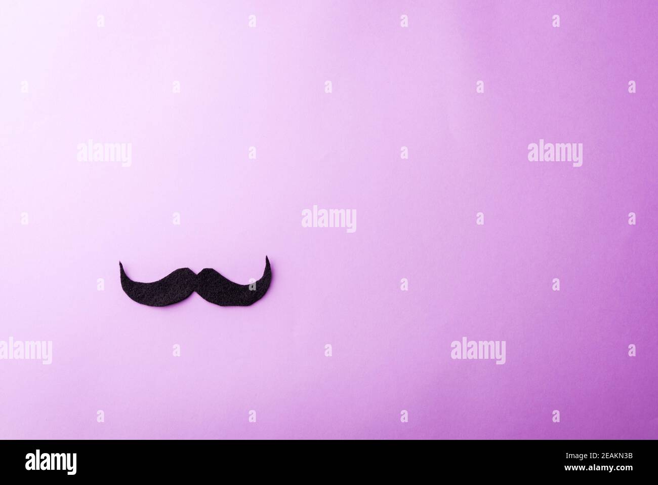 Black mustache paper on purple Stock Photo - Alamy
