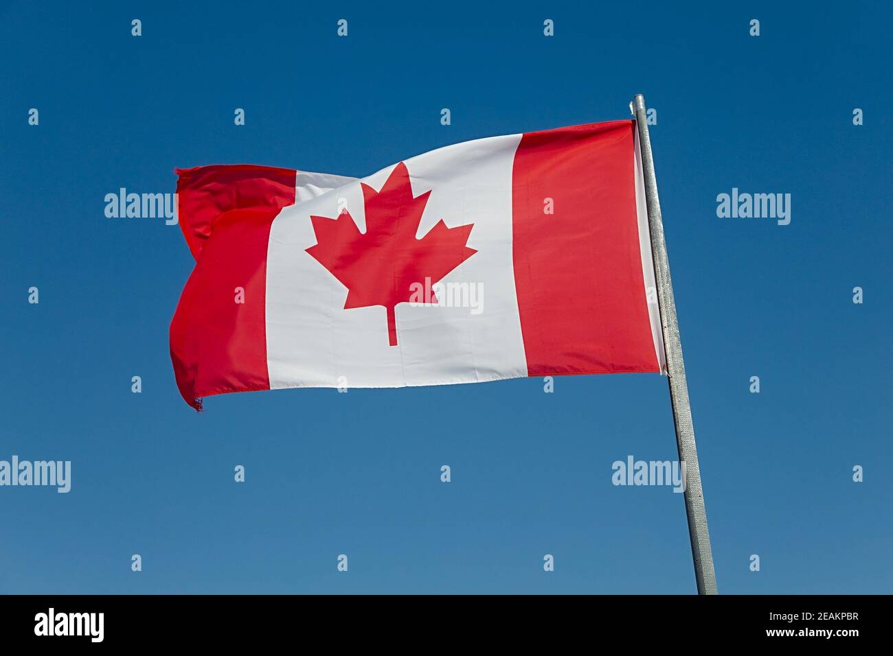 Canadian Flag Against Blue Sky Stock Photo - Alamy