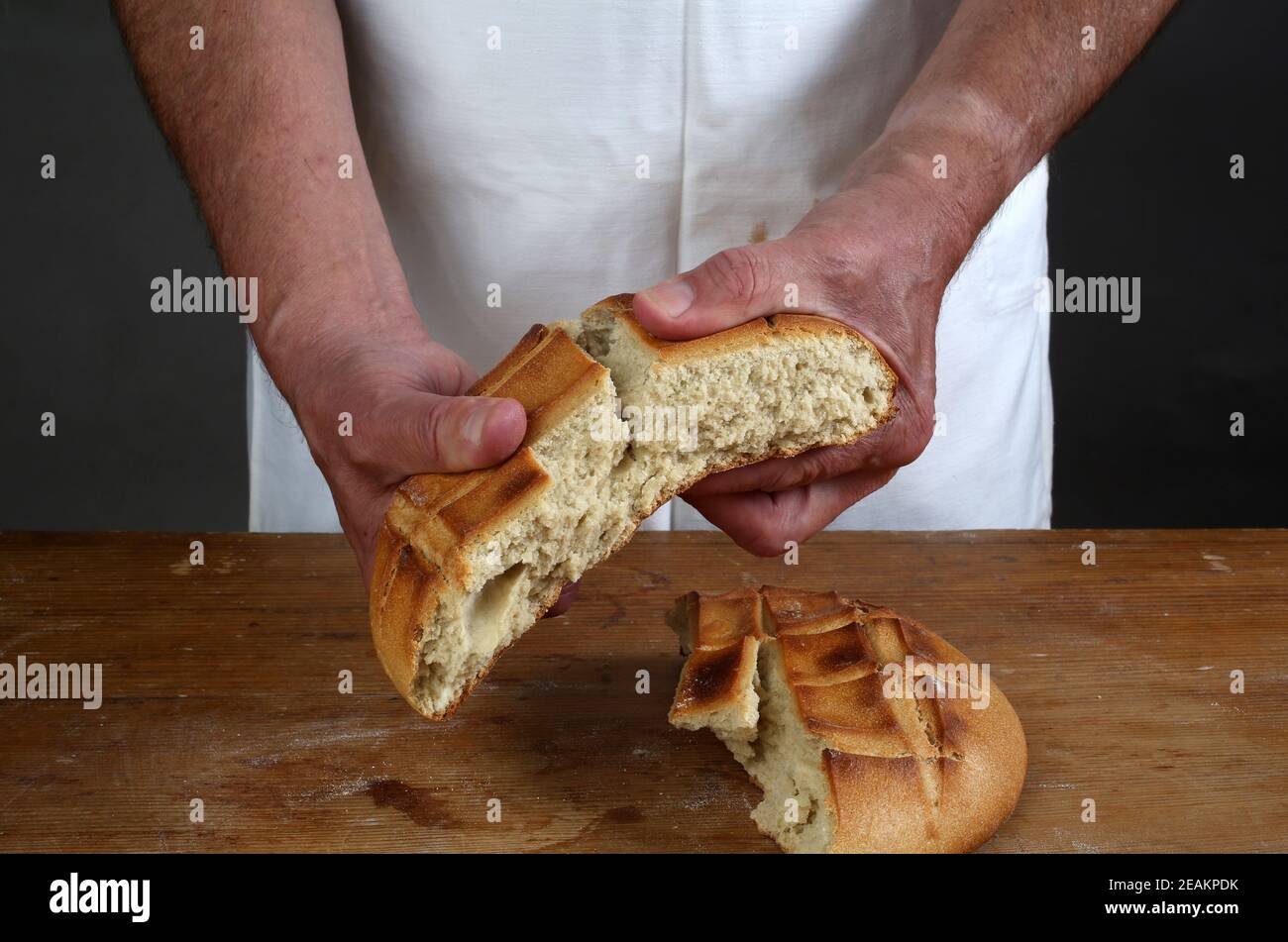 Breaking of a fresh loaf of Eucharistic bread Stock Photo - Alamy