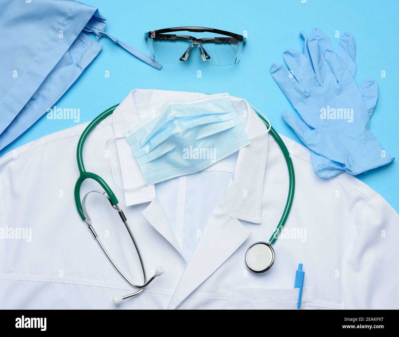 textile cap, white medical gown, disposable mask and protective plastic ...