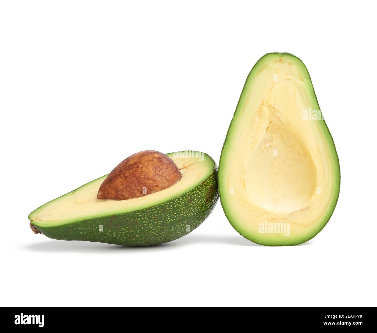 half ripe green avocado with a brown stone isolated on a white ...
