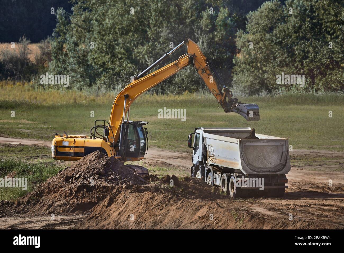 Construction site excavator and truck Stock Photo - Alamy