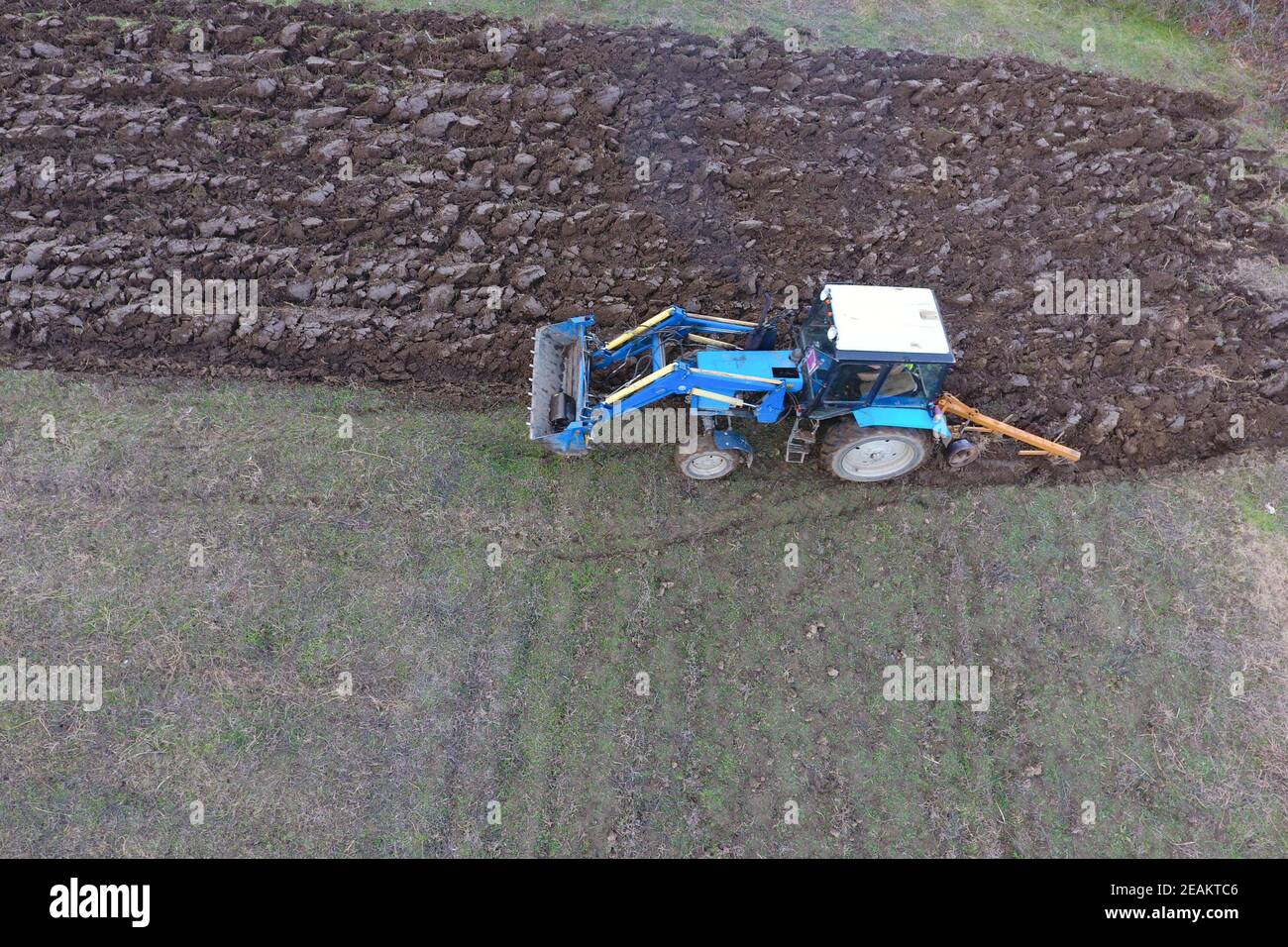 Tractor plowing the garden. Plowing the soil in the garden Stock Photo ...