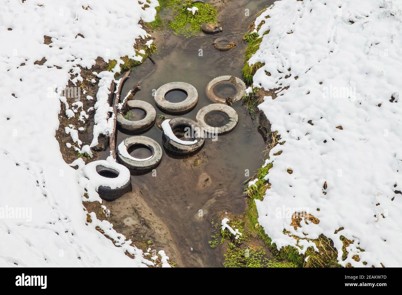 Old car tires blocked the stream that feeds the river. Environmental ...