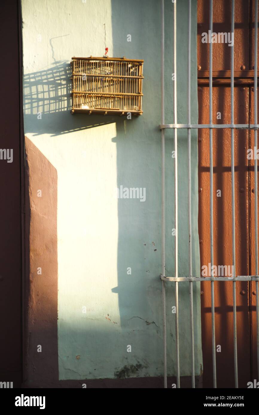 Vertical shot of a wooden cage hanging on a wall Stock Photo - Alamy