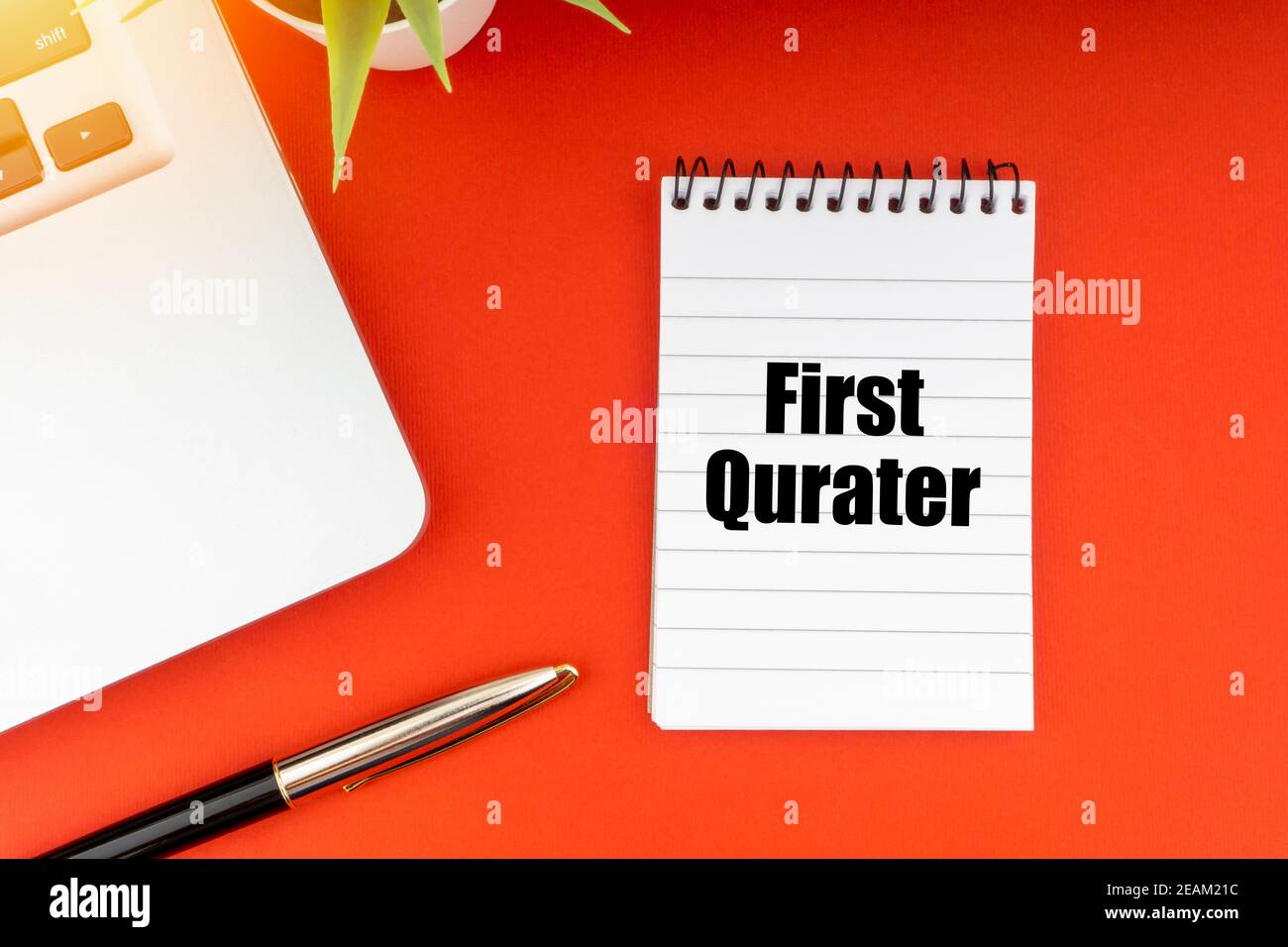 FIRST QUARTER text with notepad, laptop, fountain pen and decorative ...