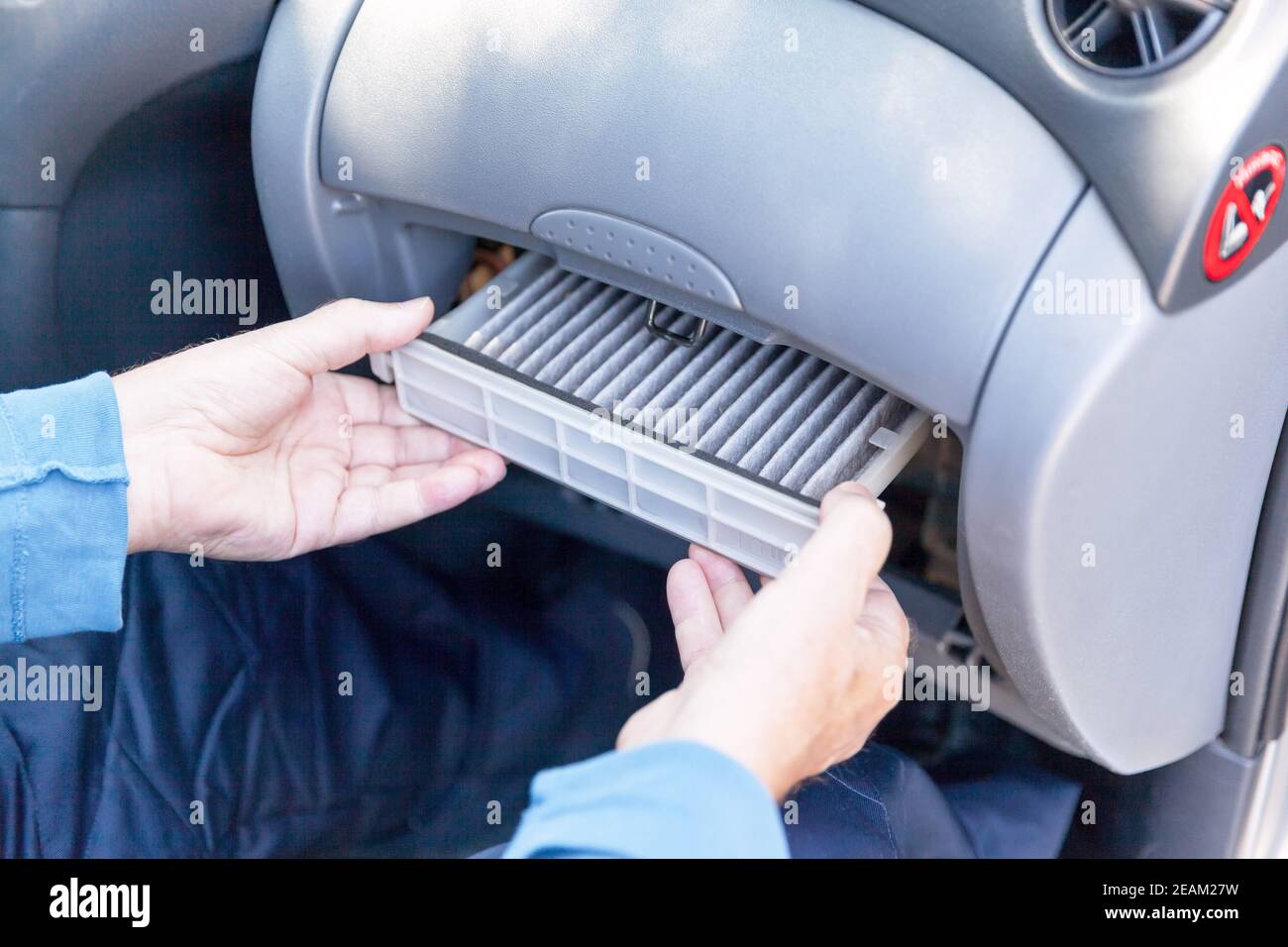 Replacing dirty cabin pollen air filter for a car Stock Photo - Alamy