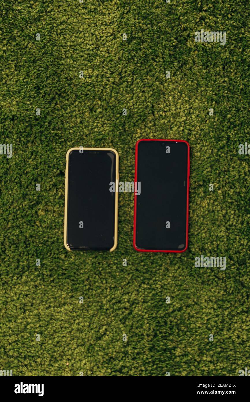 Two Generations of Smartphones on Grass Stock Photo - Alamy