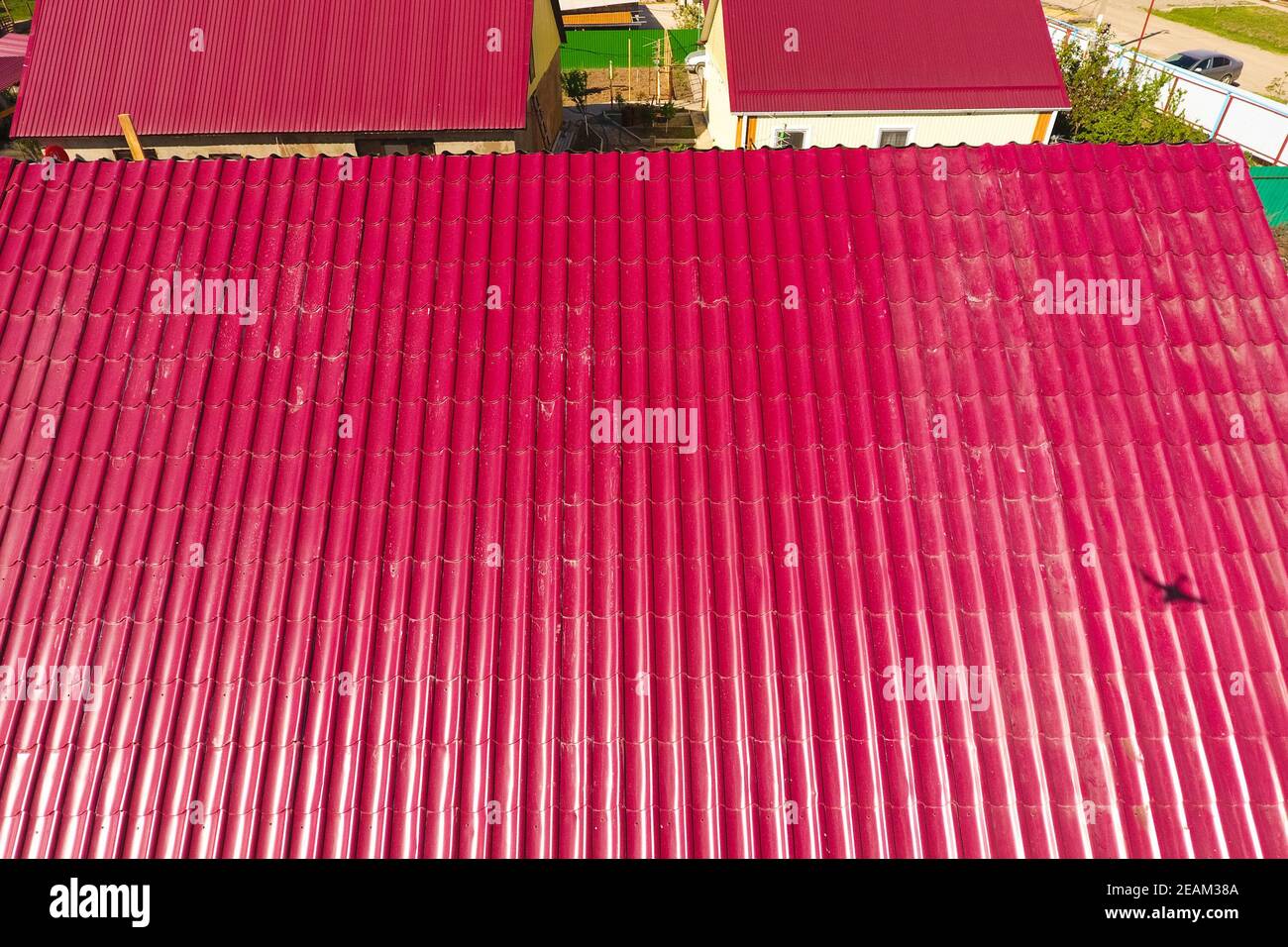 A house with a red roof made of corrugated metal sheets. Roof from ...