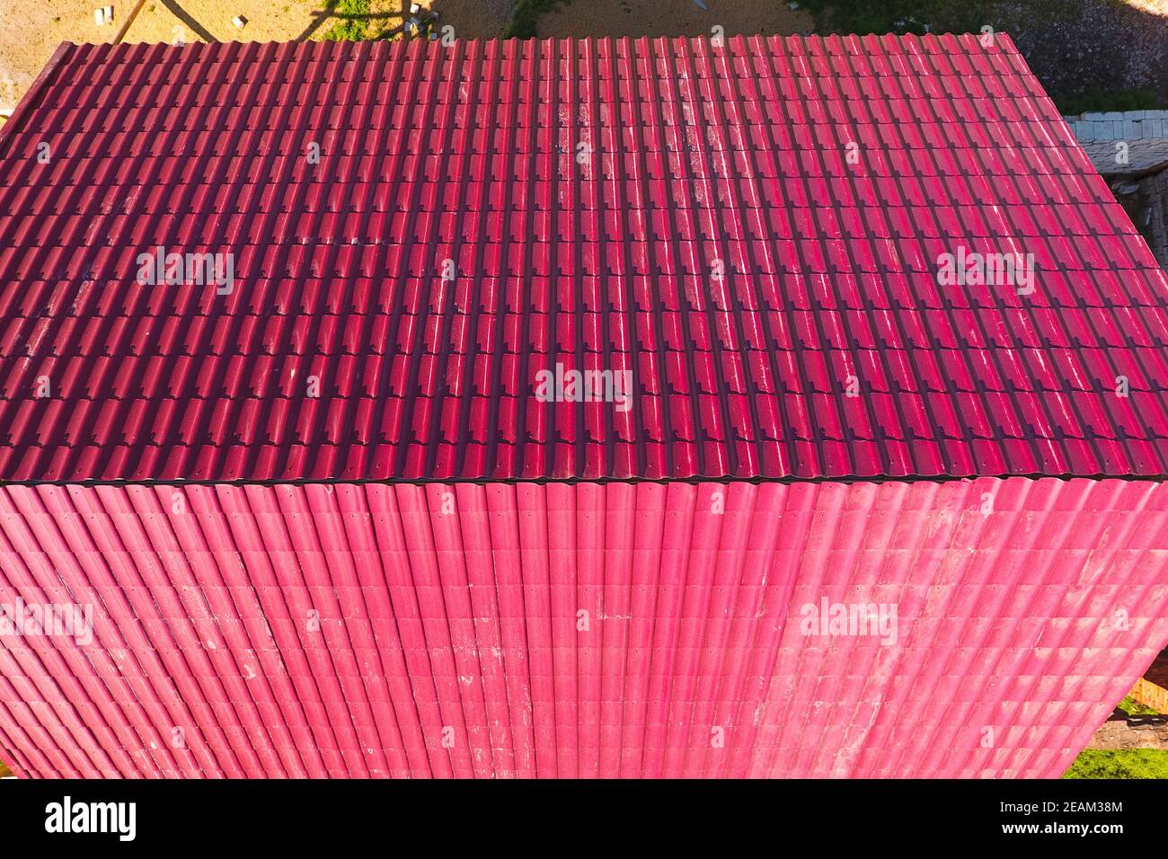 A house with a red roof made of corrugated metal sheets. Roof from ...