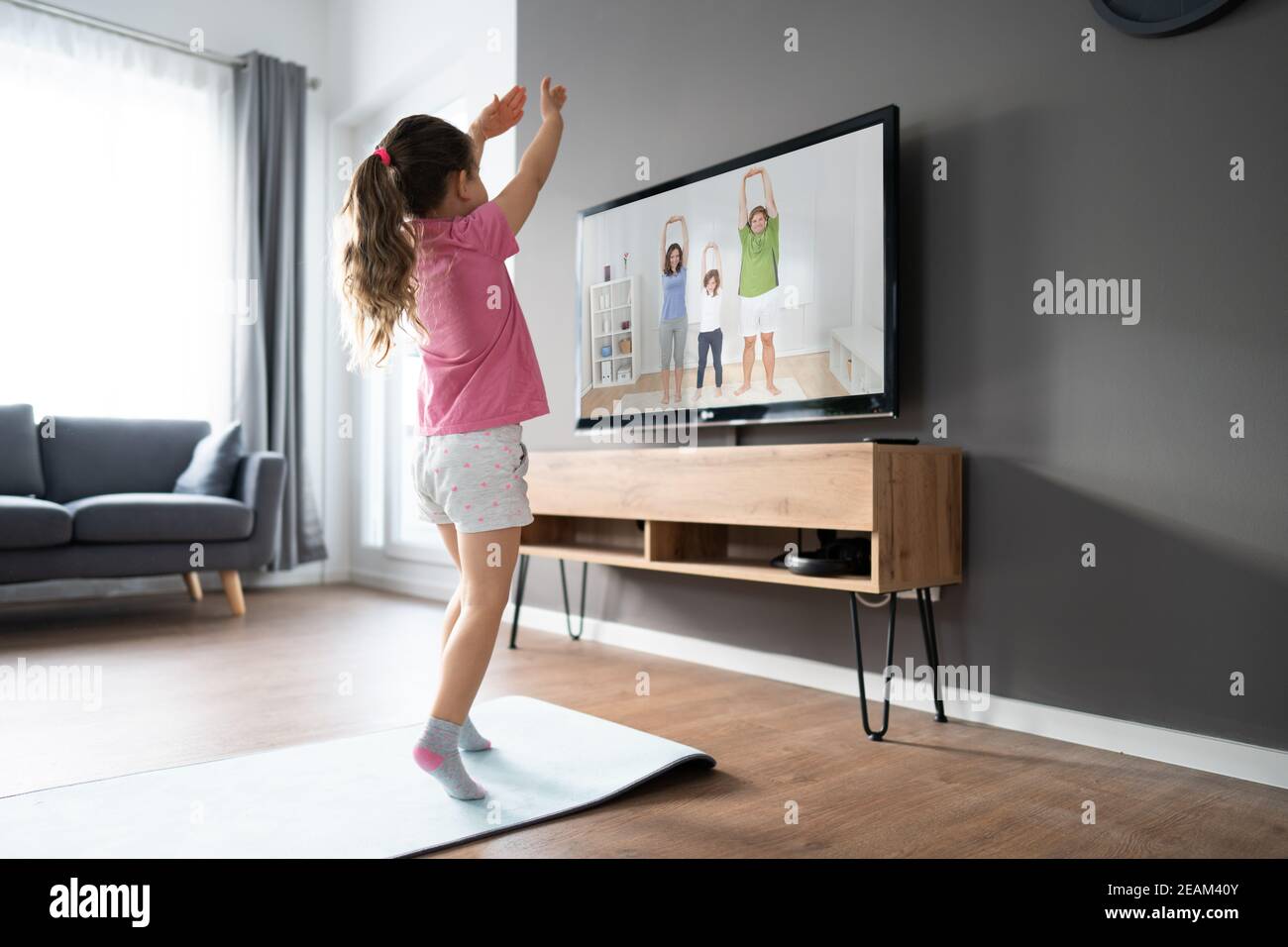 Kid Doing Online TV Fitness Exercise Stock Photo - Alamy