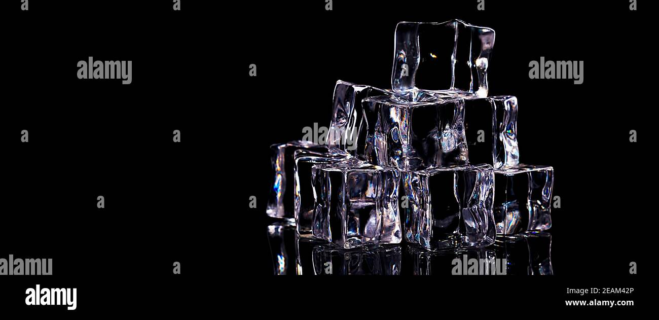 Ice cubes are arranged in a slide, isolated on a black background Stock ...