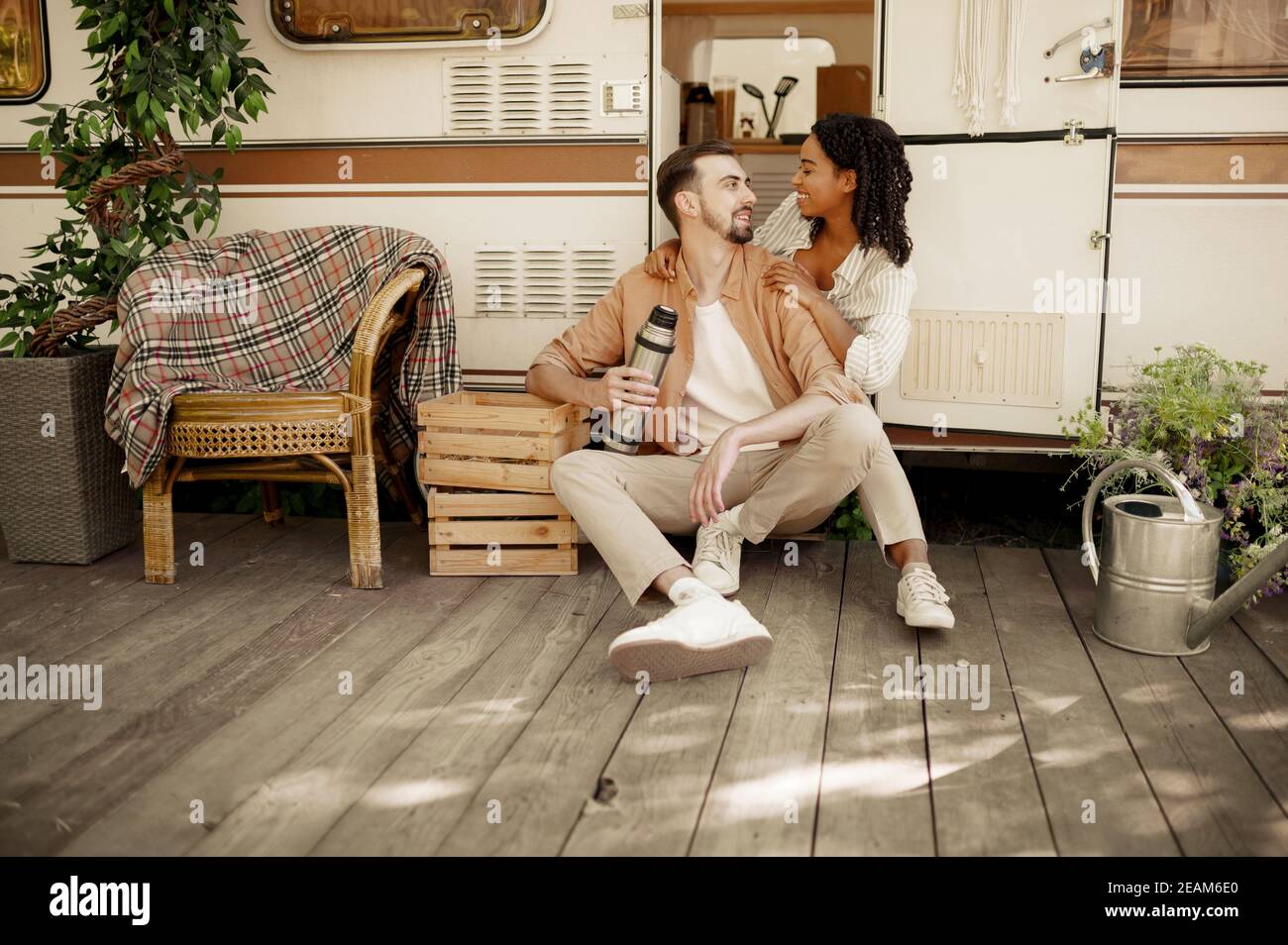 Couple with thermos in rv, camping in a trailer Stock Photo - Alamy