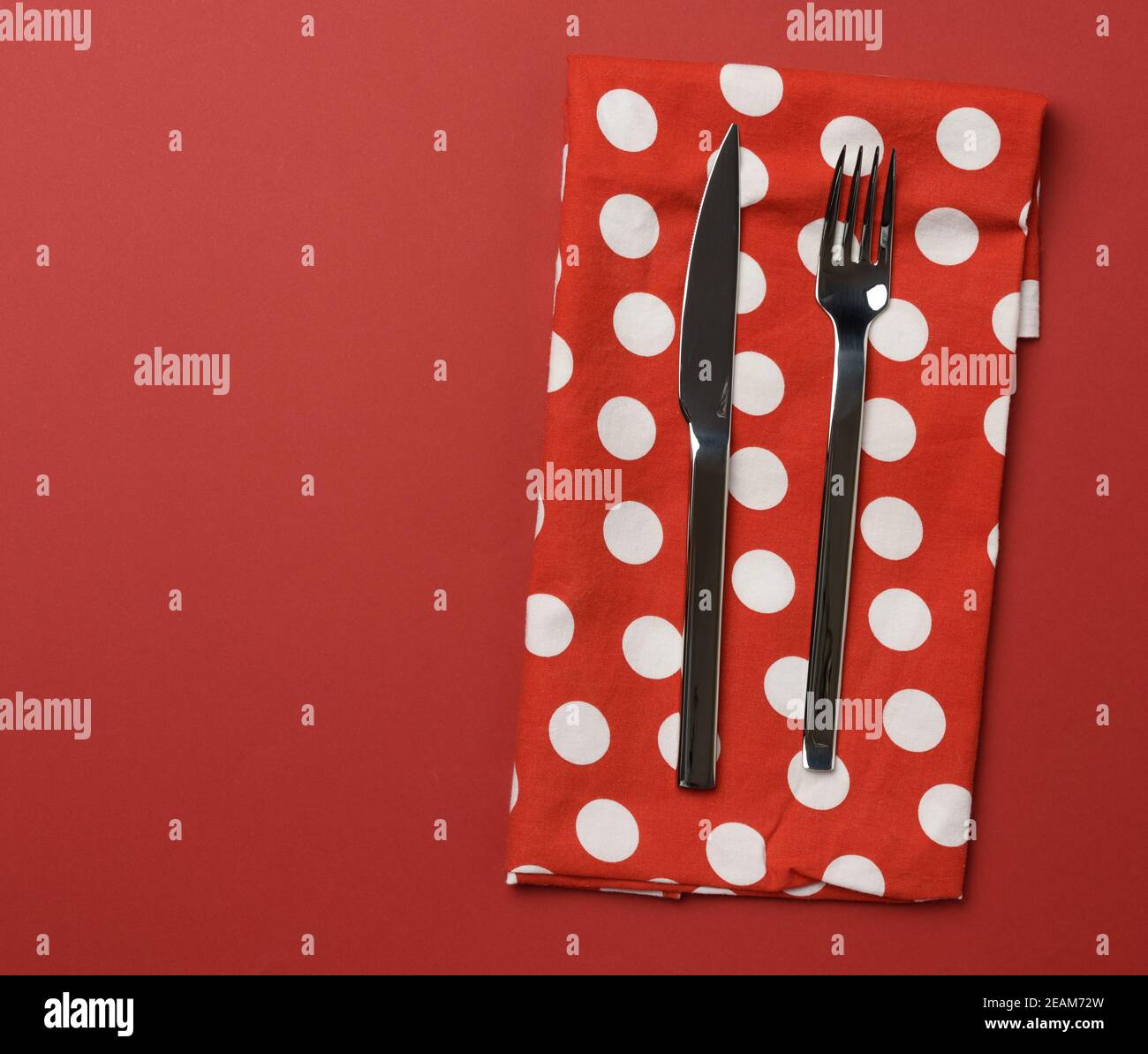 metal fork and knife , red background Stock Photo - Alamy