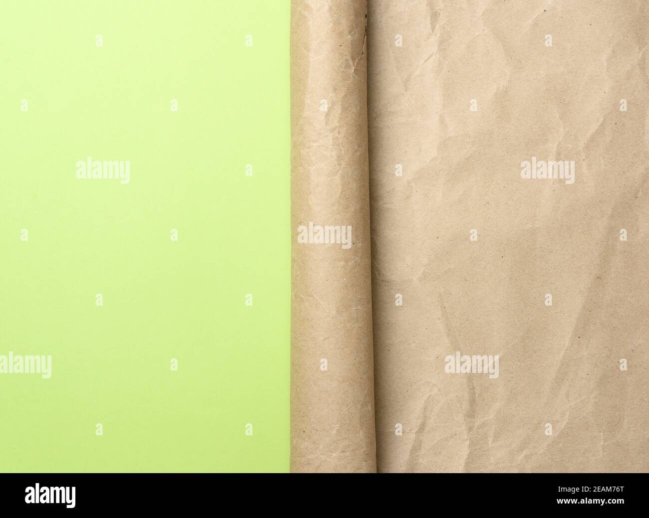 folded corner of a roll of brown paper on a green background Stock ...