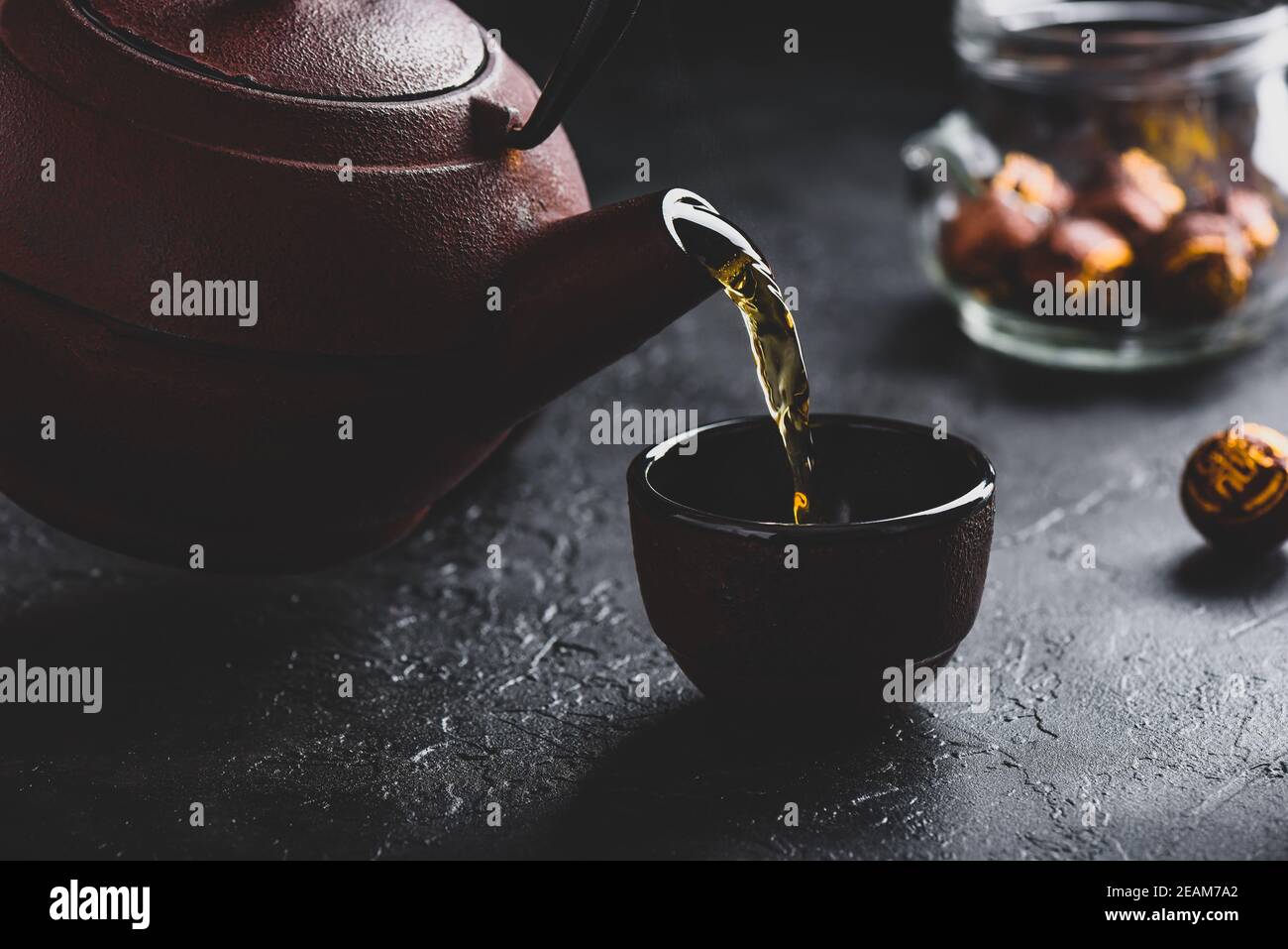 Pouring ready red tea into tea bowl Stock Photo - Alamy
