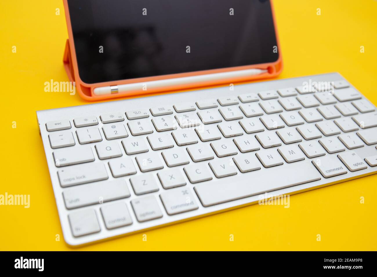 Closeup of a modern wireless keyboard with a tablet isolated on a ...