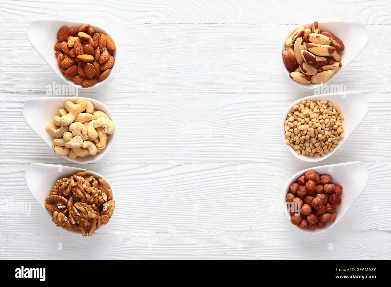 Assorted peeled nuts in a white bowl. Six types of nuts. Natural ...