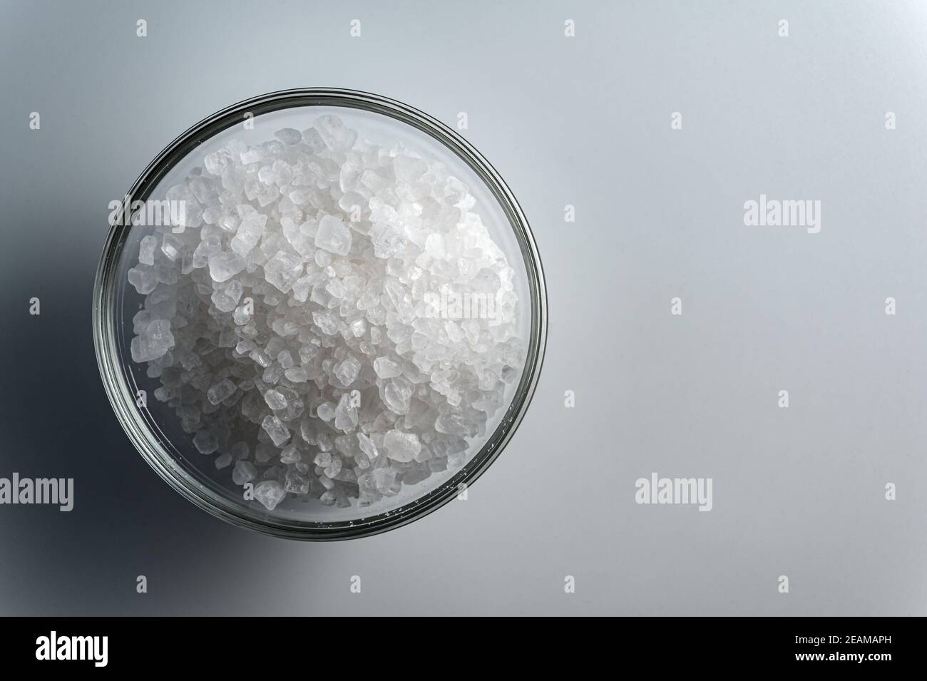 Glass bowl of sea salt on white background with empty space Stock Photo ...