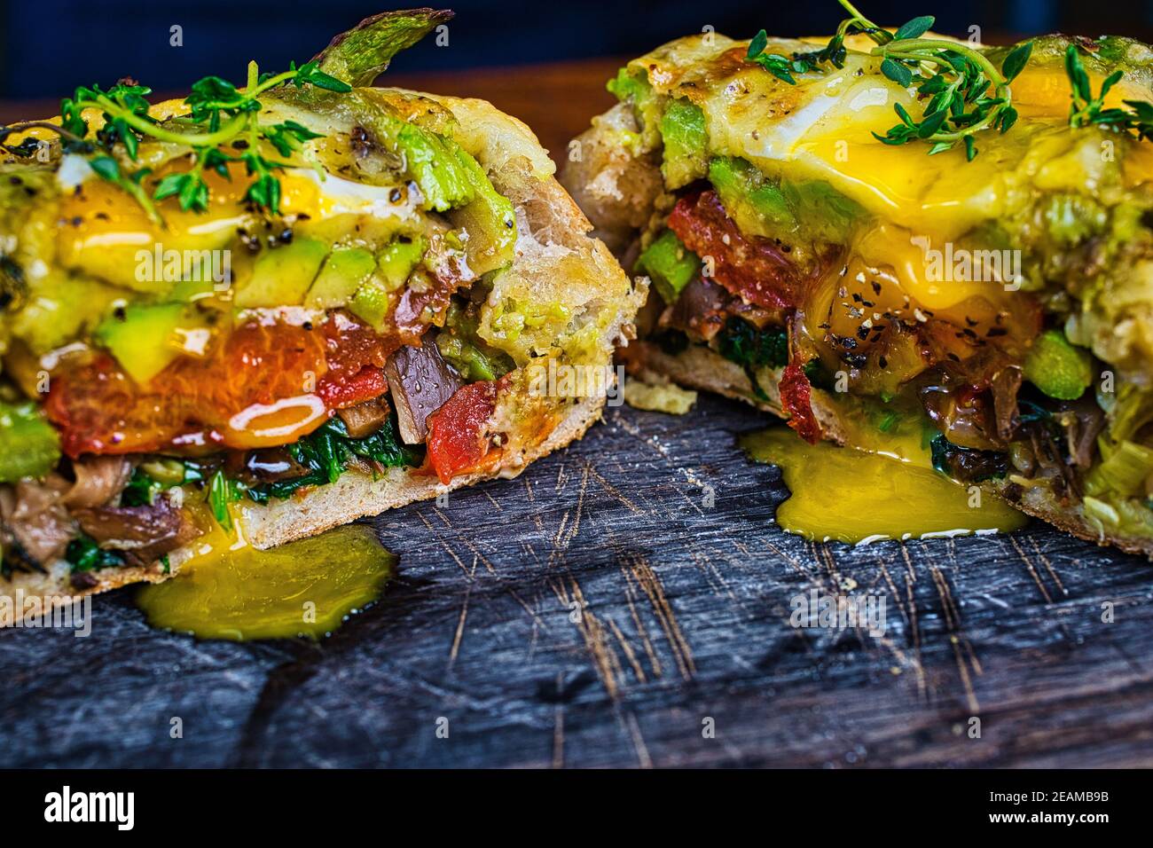 Vegetarian loaded bread loaves filled with slow-roasted tomato, spinach ...