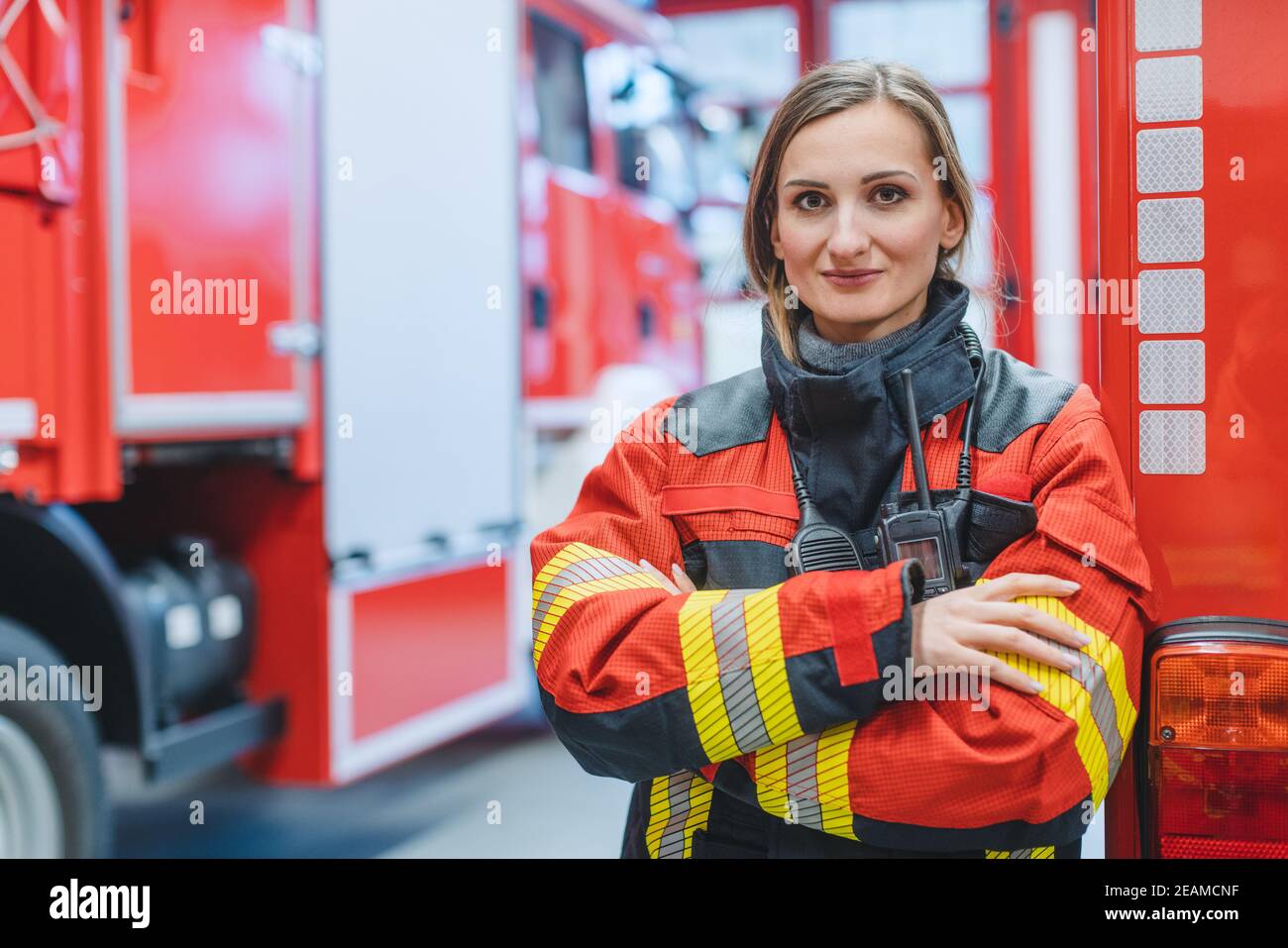 Fire fighter woman standing in front of a fire truck Stock Photo - Alamy