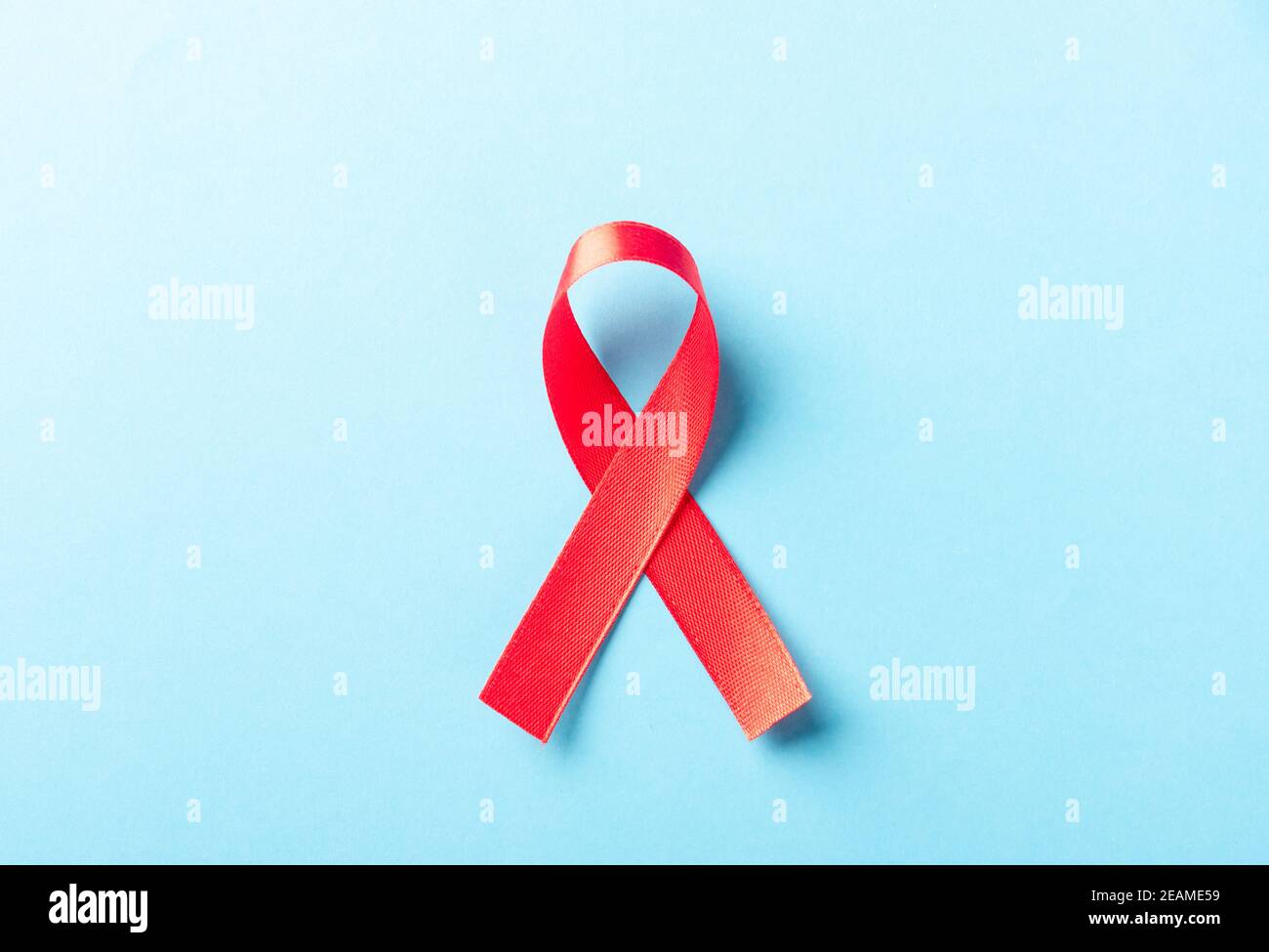 Red bow ribbon symbol HIV, AIDS cancer awareness Stock Photo - Alamy