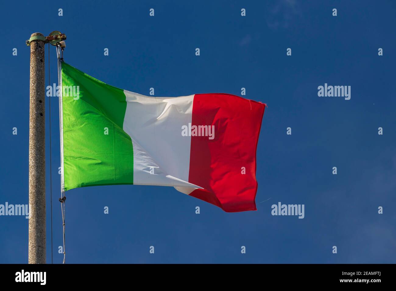 Italian flag blowing in the wind in the blue sky Stock Photo - Alamy