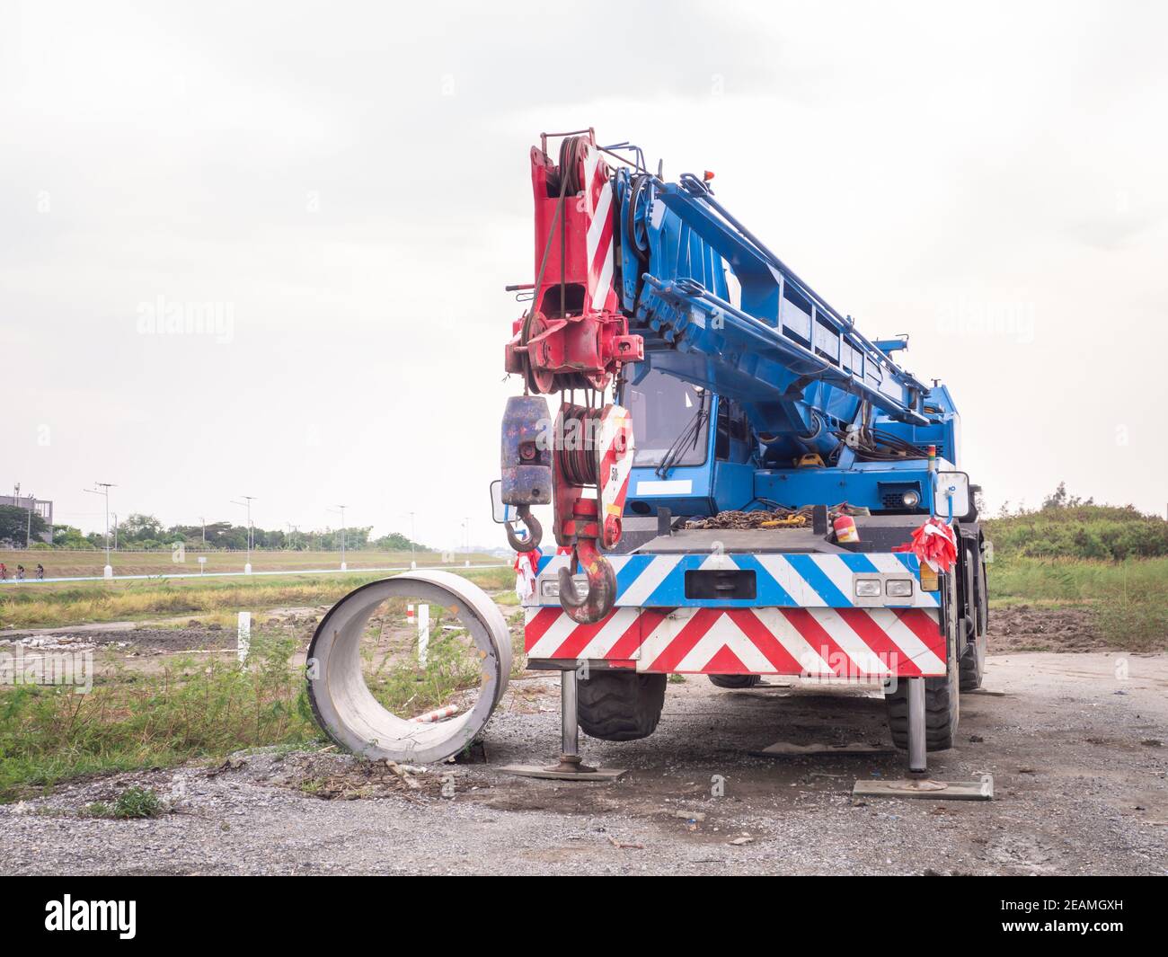 Construction site crane is lifting a led signboard for advertisement ...