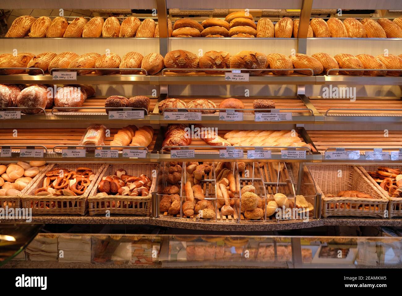 Modern bakery with different kinds of bread, cakes and buns in ...