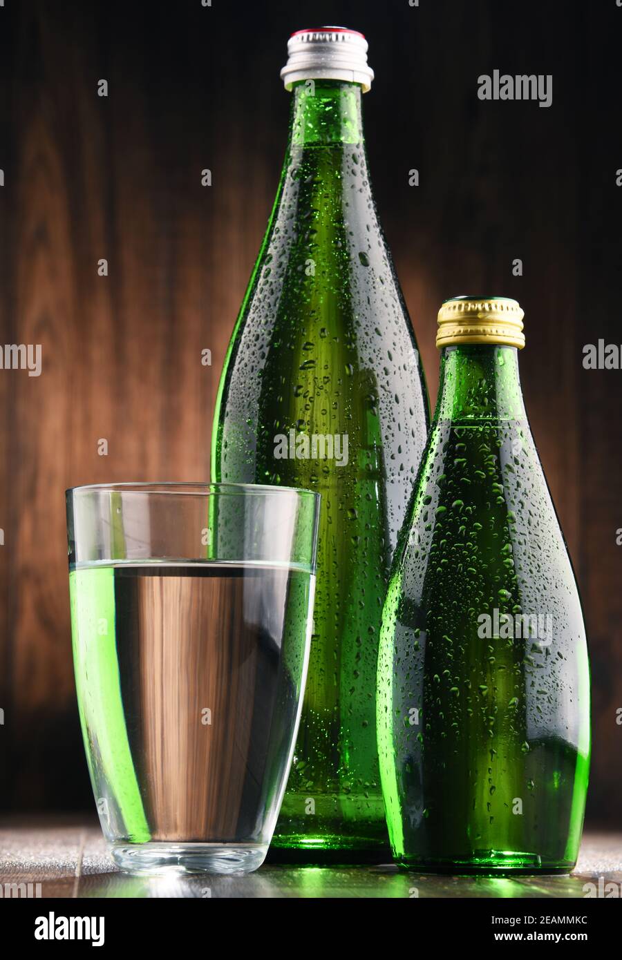 Composition with glass and bottles of mineral water Stock Photo - Alamy