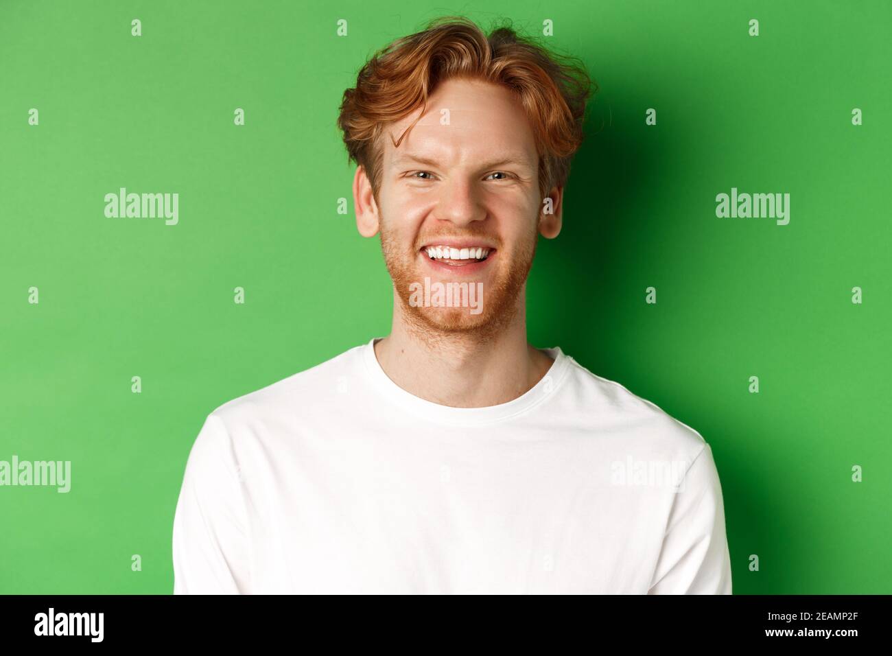Emotions and fashion concept. Happy young man with red hair and beard ...