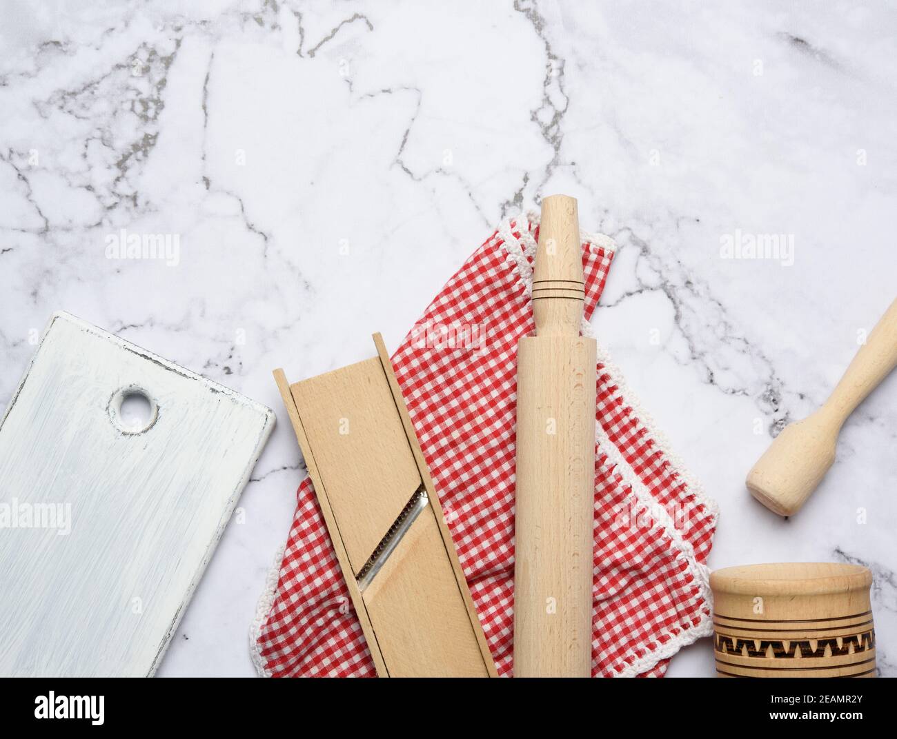 wooden kitchen utensils on white marble table Stock Photo - Alamy