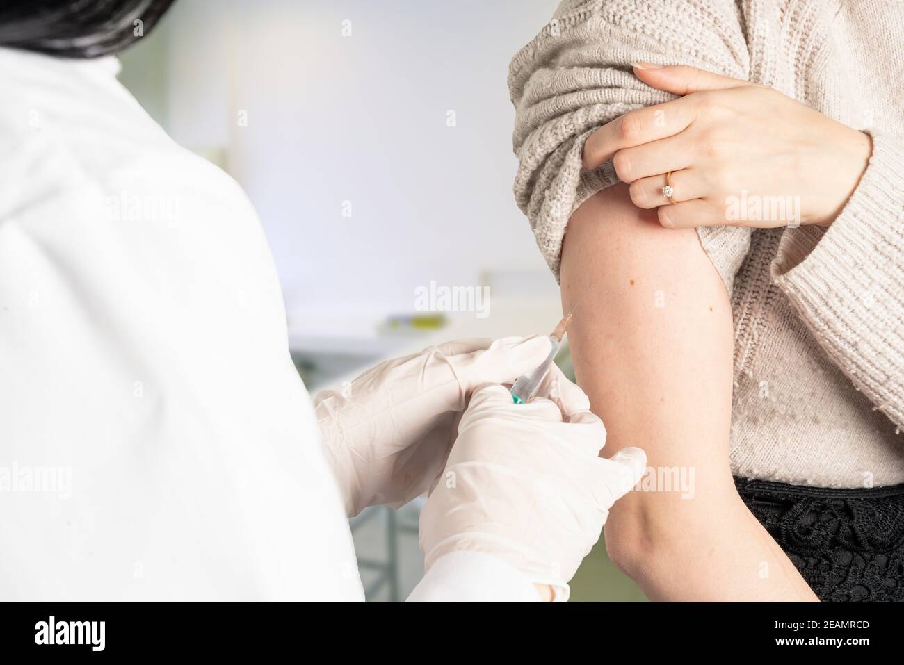 doctor vaccinates a patient with a syringe on her arm Stock Photo - Alamy