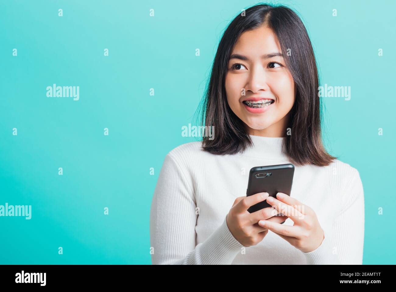 woman smile she holding and typing text message Stock Photo - Alamy