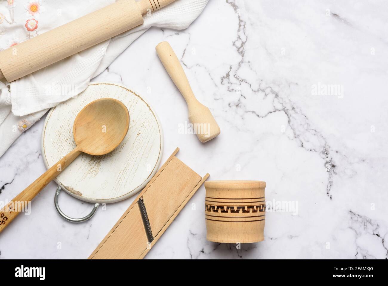 wooden kitchen utensils on white marble table Stock Photo - Alamy