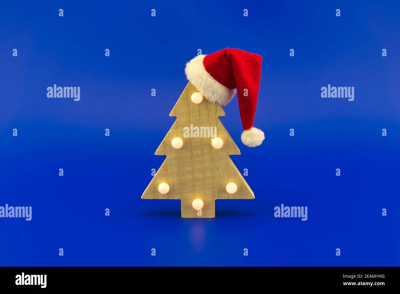 Christmas tree with red Santa hat Stock Photo - Alamy