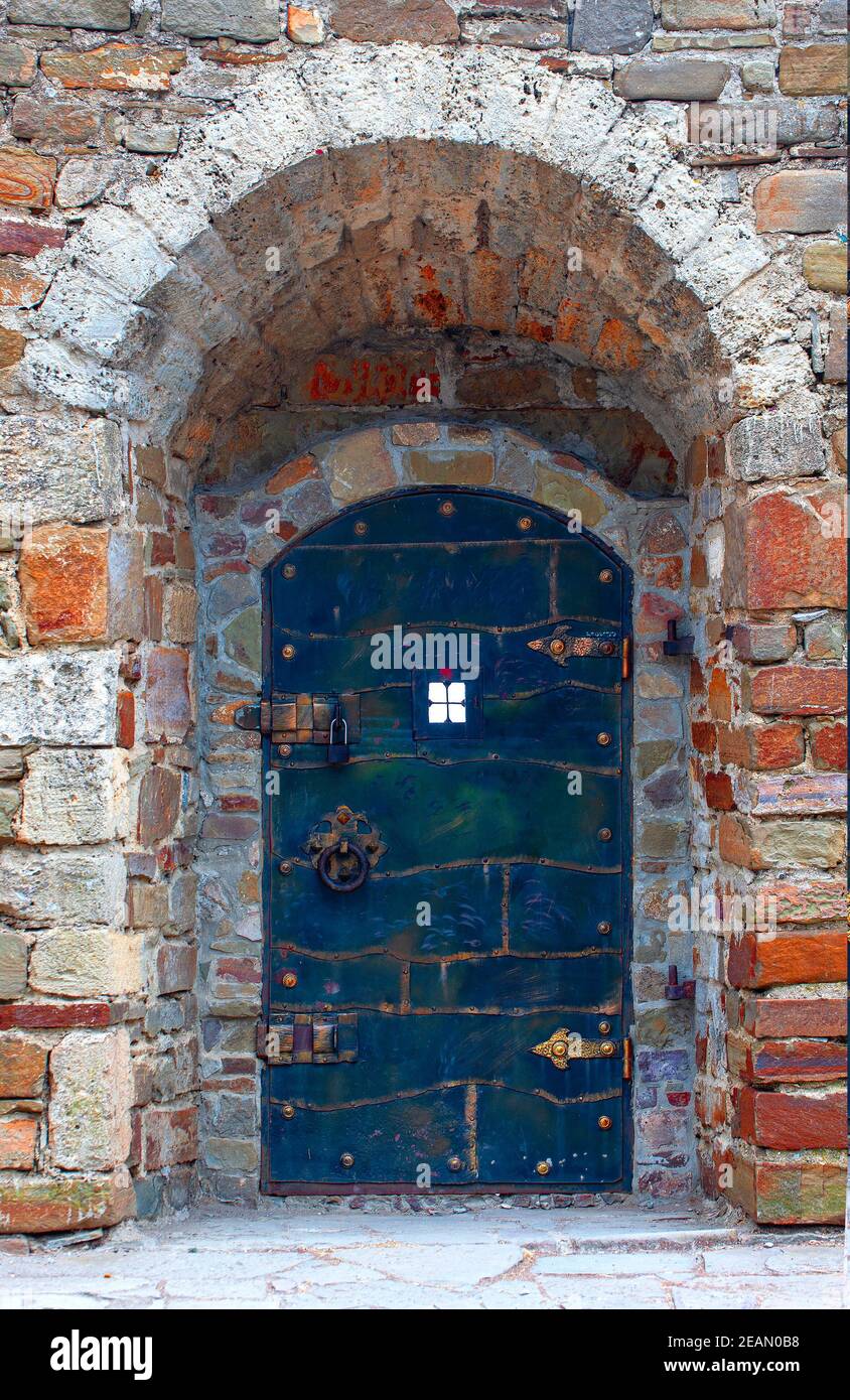 old metal door with stone masonry with lock Stock Photo - Alamy