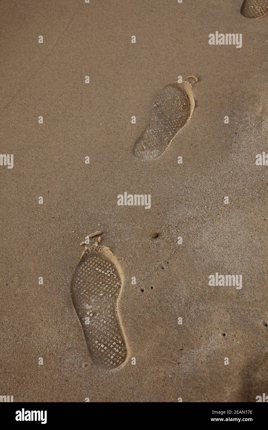 Human trace of a foot on yellow sand Stock Photo - Alamy