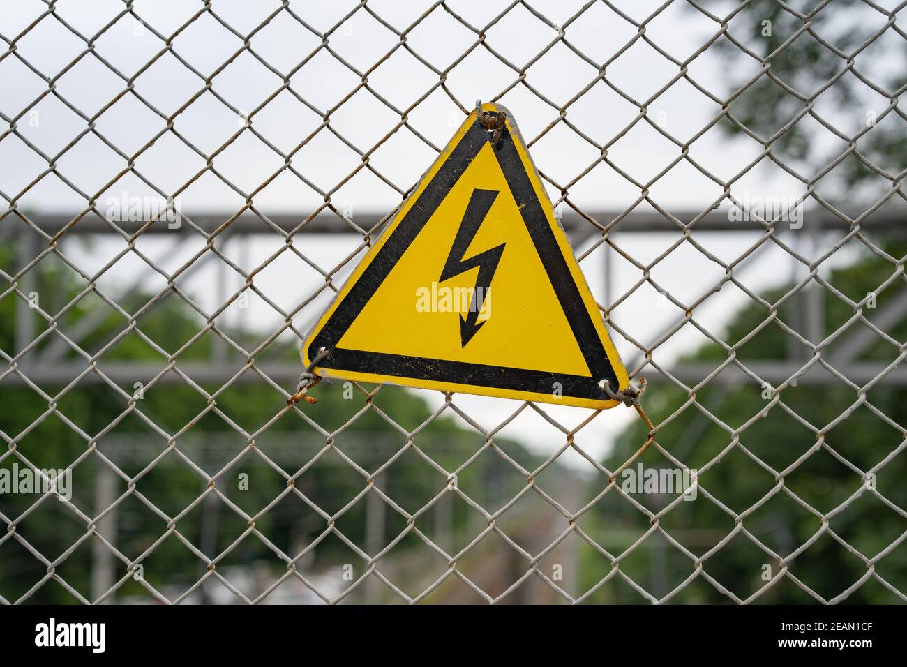 yellow triangle with black lightning on a metal mesh background Stock ...