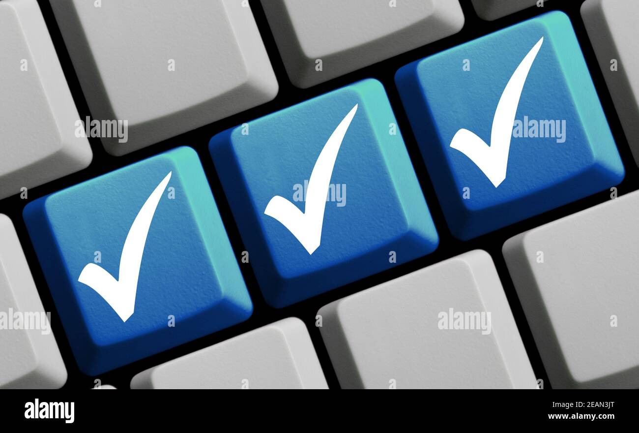 3 Check marks on blue computer keyboard Stock Photo - Alamy