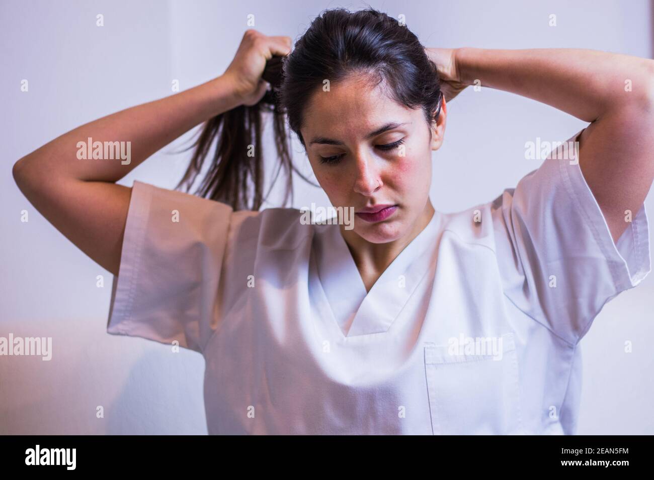 Caucasian nurse getting ready for work Stock Photo - Alamy